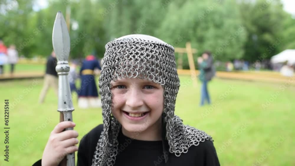 happy boy in the ring of the middle ages on a holiday, a smiling child ...