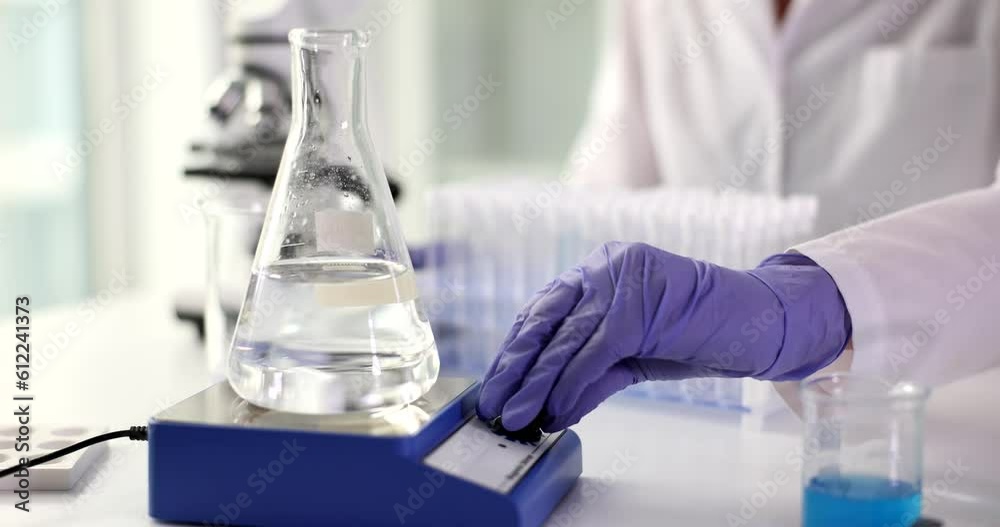 Mechanical stirring in round-bottomed flask mix liquid of transparent ...