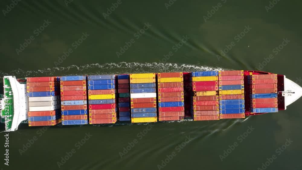 Aerial top down view of large container cargo ship traveling with slow ...