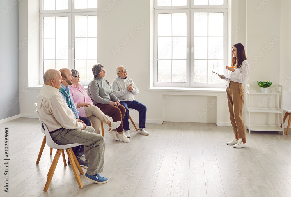 Group of elderly people meeting with psychologist or coach. Old men and ...