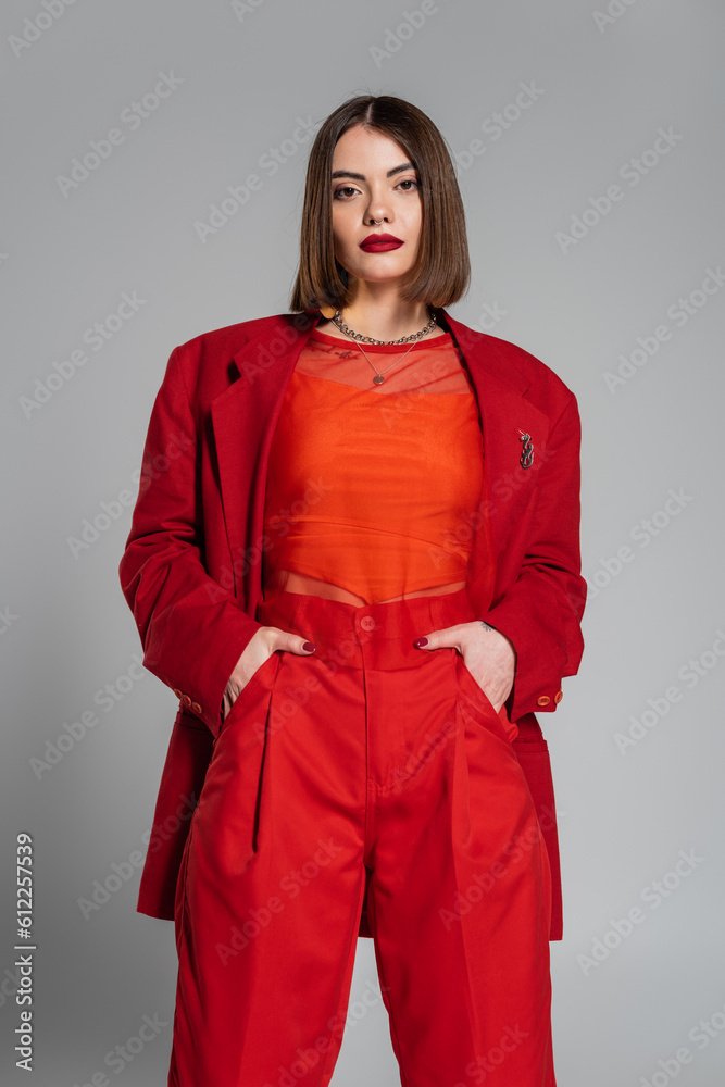 fashion look, young woman with short hair and nose piercing posing in ...