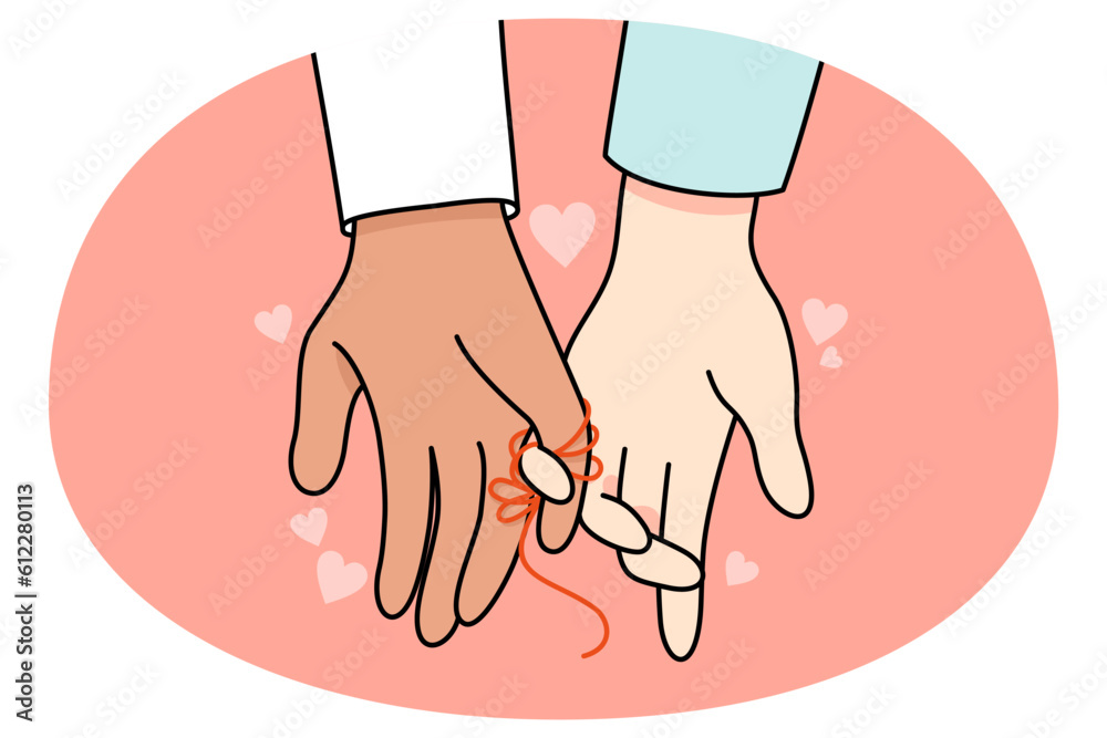 Multiracial couple hands tied with red thread as symbol of bonding and ...