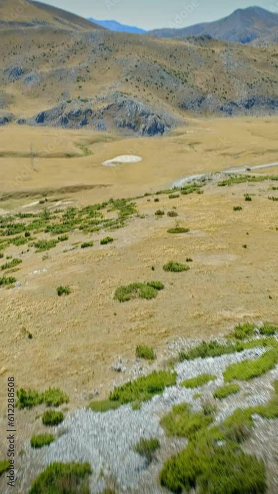 Beautiful landscape, drone flight over dry grass mountain slopes ...
