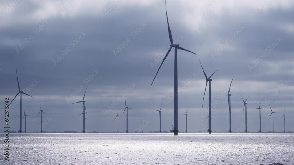 An offshore wind farm in the early morning light. Windpark Fryslân was ...