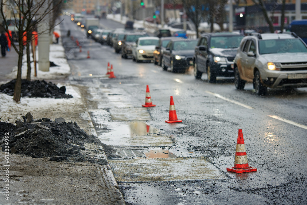 Road repair, removing holes in asphalt surface, restore pavement damage ...