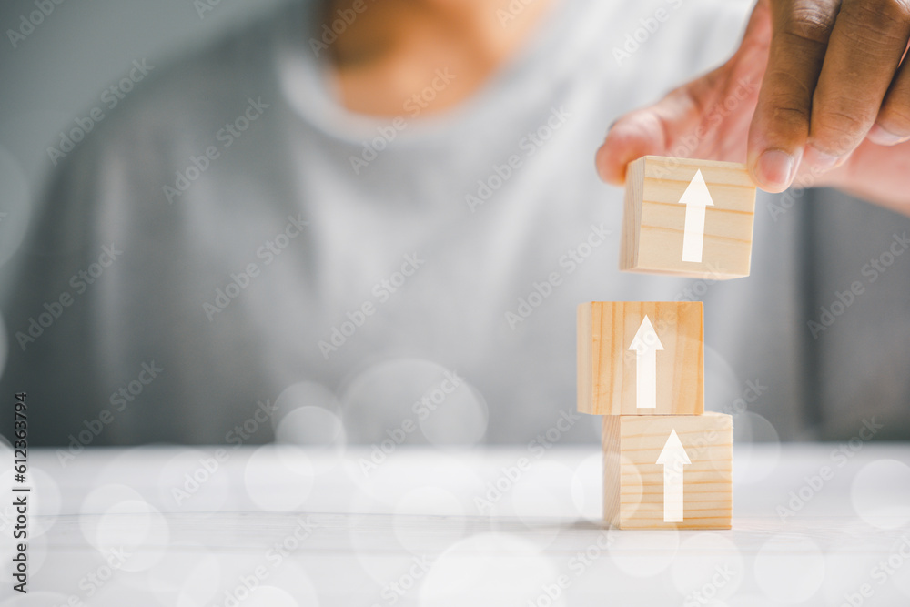 Wooden block stacking forming ladder-like structure with upward arrow ...