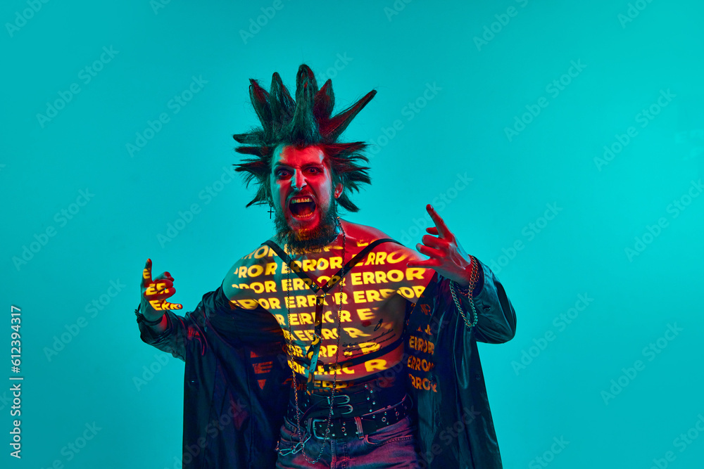 Rock and roll. Young man, rock musician, punk with neon filter ...