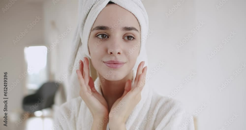 Woman with perfect healthy skin touching face with hands enjoying ...