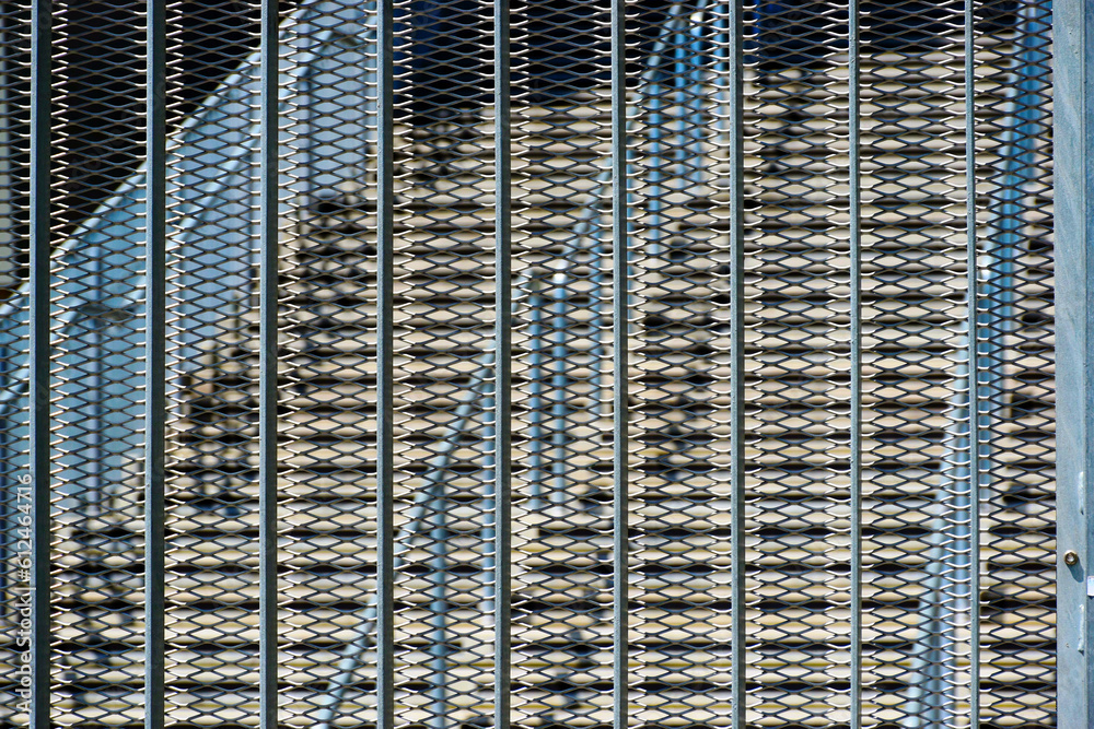 galvanized gray metal mesh and vertical picket fence. translucent ...