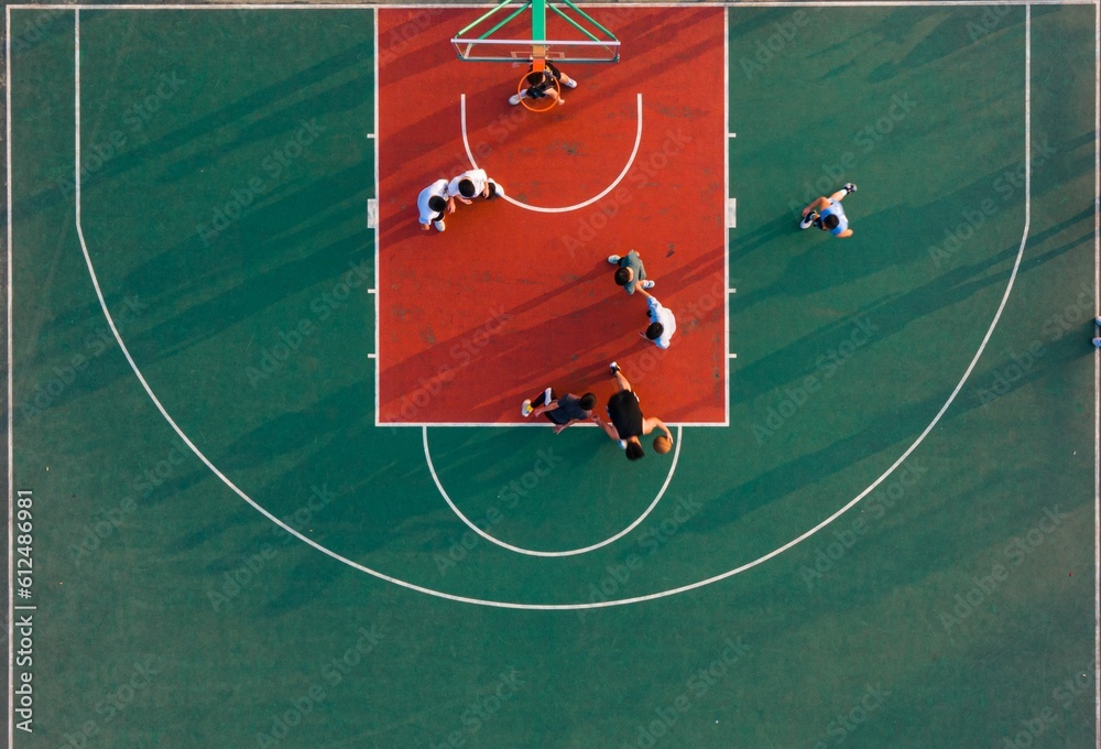 Aerial top view of a basketball court and young people playing the game ...