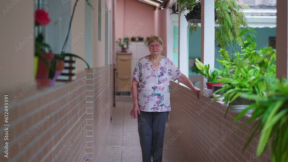 Elderly mature senior woman standing at home, domestic authentic real ...