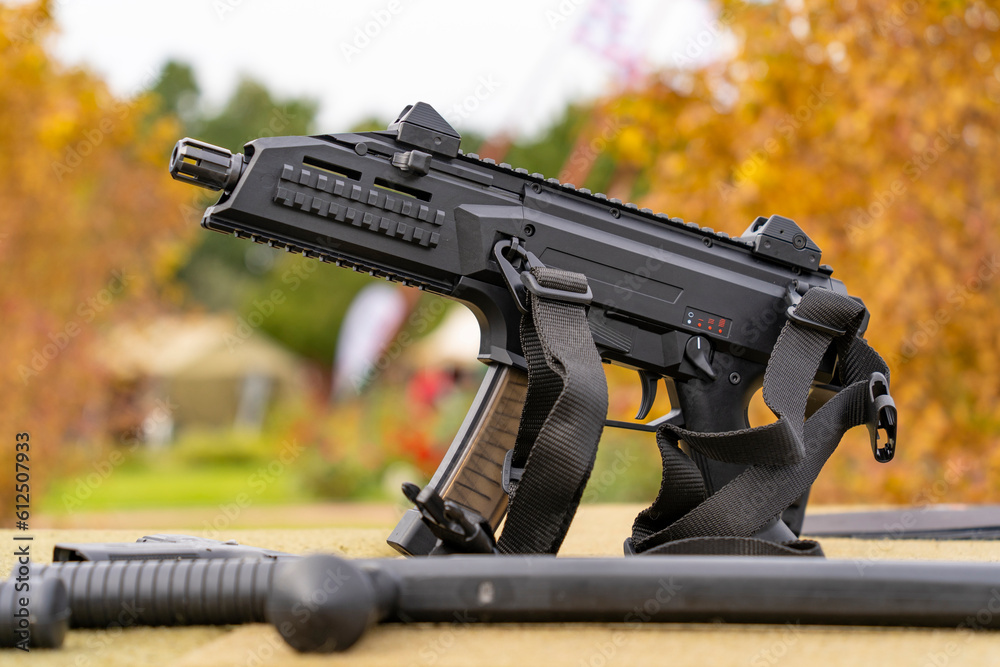 Modern submachine gun with black belt on autumn background Stock Photo ...