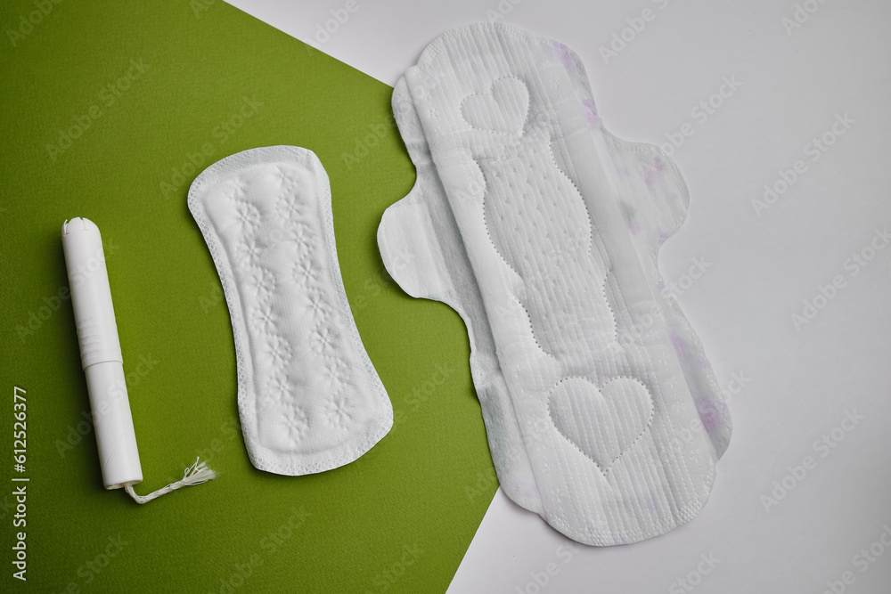 Women's pads and tampon. Sanitary pads lie next to a tampon on an ...