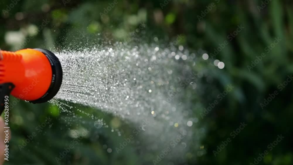 Close-up of a stream of water pouring from a sprinkler. Water plants ...