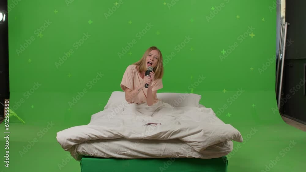 Happy sleepy young adult woman waking up lying in comfortable white bed ...