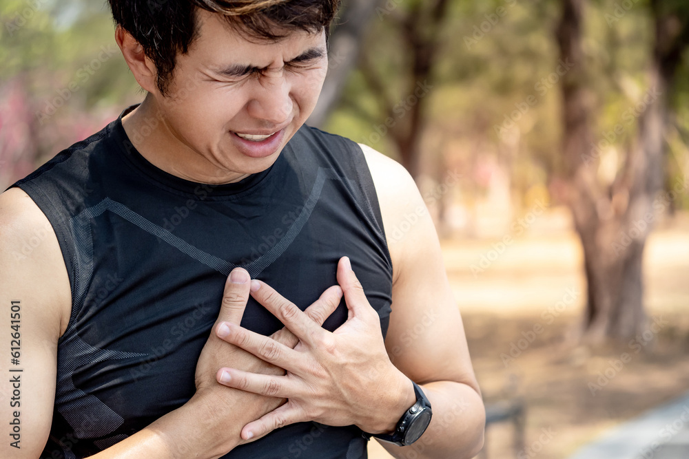 Severe heartache. Athlete man clutching his chest from acute pain ...