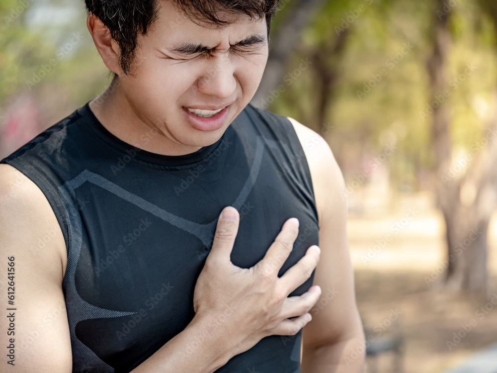 Severe heartache. Athlete man clutching his chest from acute pain ...