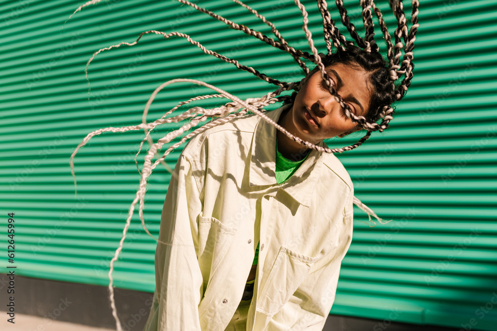 Cool Indian woman with flying braids on street Stock Photo | Adobe Stock