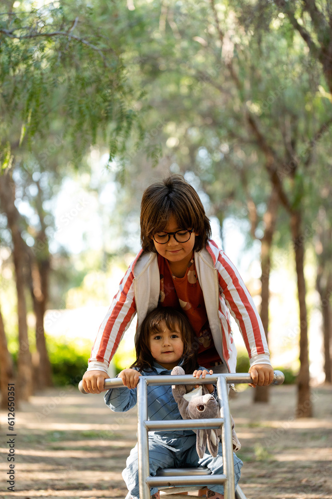 Kids playing with a circular seesaw outdoors Stock Photo | Adobe Stock
