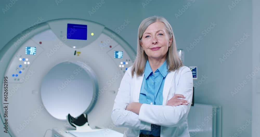 Portrait of female doctor at background of MRI capsule. Middle-aged ...