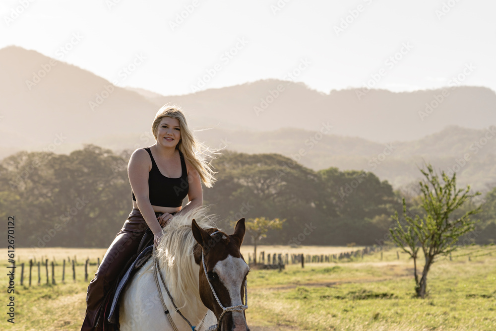 Beautiful woman riding a horse Stock Photo | Adobe Stock