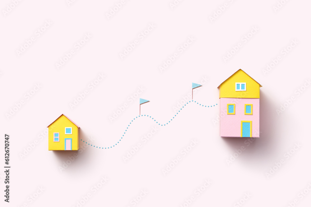 Papercraft houses connected by dotted line and flags. Stock Photo ...