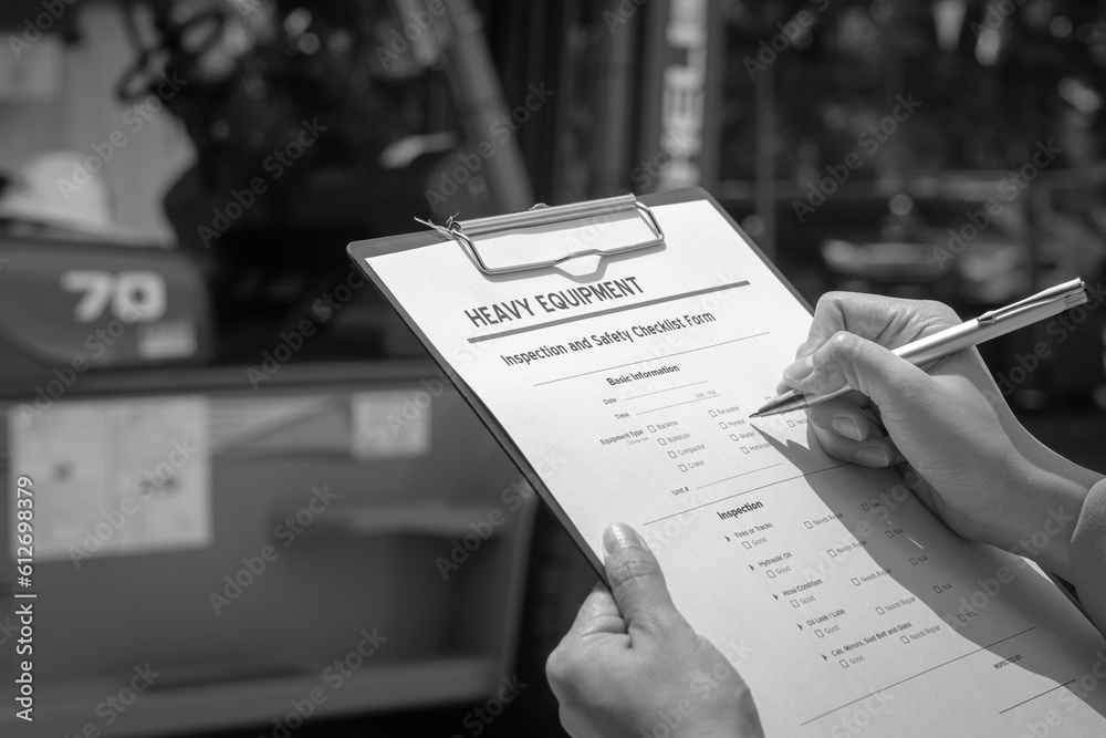 A mechanical engineer is using heavy equipment checklist form for ...