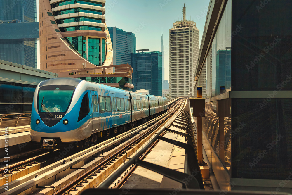 Train on railroad of Dubai subway in business district at urban ...