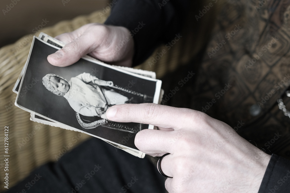 close-up male hand holding old vintage photos in sepia color 50s, 60s ...