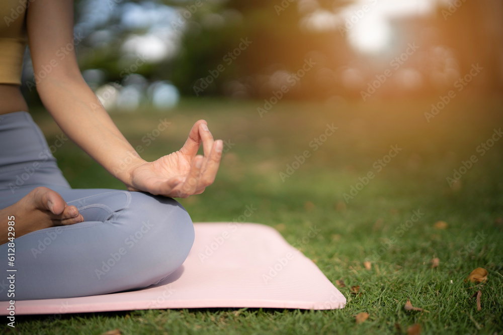 Close up woman hand doing meditation at park with light shading and ...