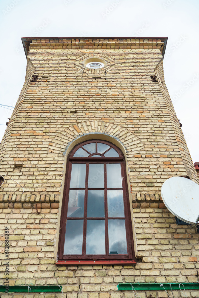 An old historical building made of red brick and vintage arched windows ...
