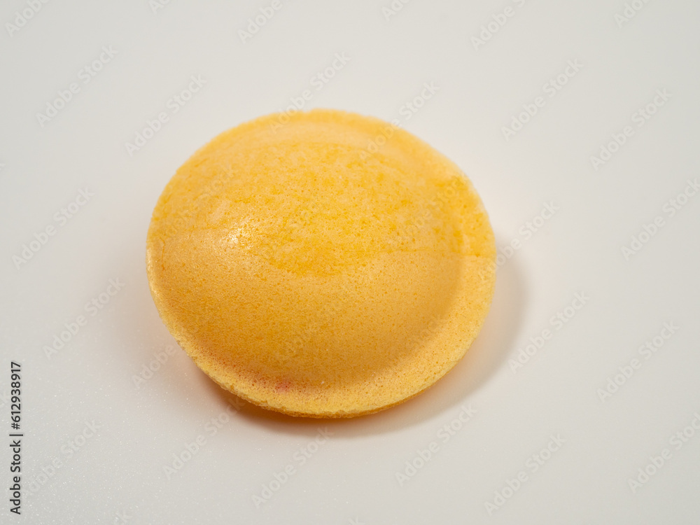 Sweet candies in the shape of a UFO in different colors on a white ...