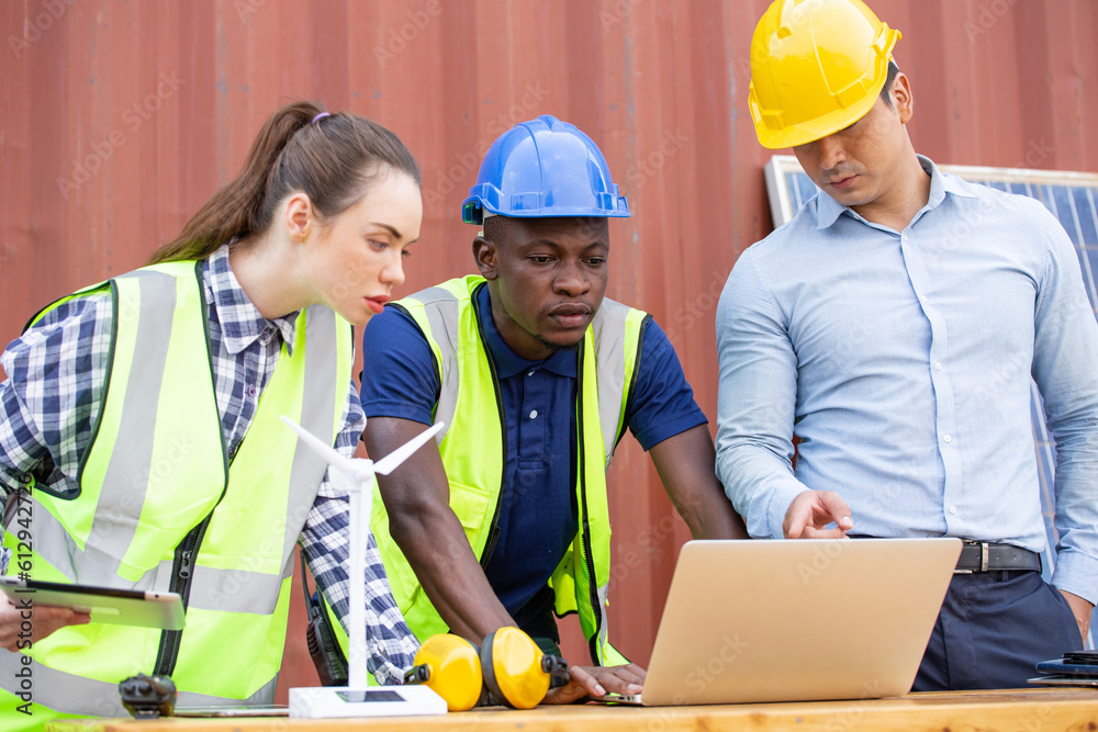 Engineer worker team discussing of solar energy from wind turbine model ...
