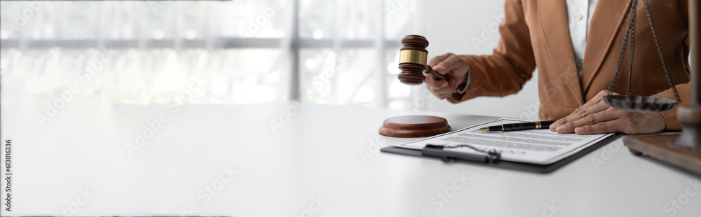 The judge is signing the document. hammer with justice lawyer ...