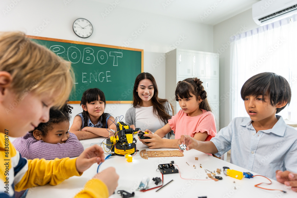 Caucasian woman teacher teaching a lesson to kids at elementary school ...