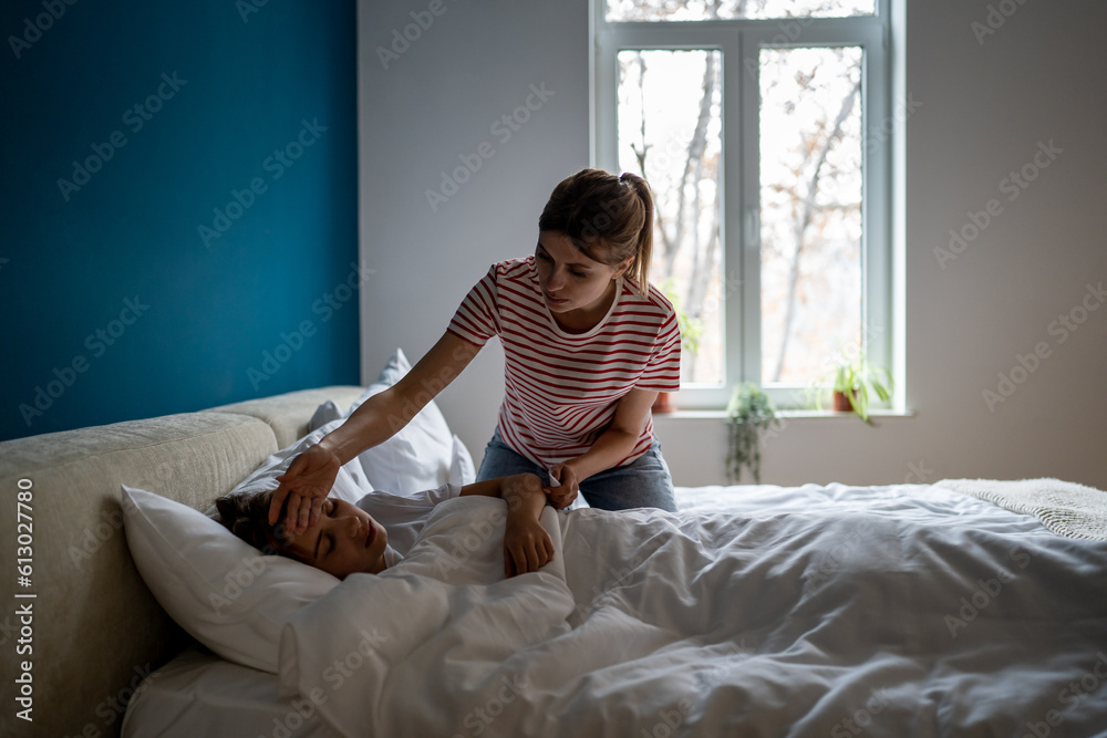 Childrens health. Worried European woman mother checking temperature of ...