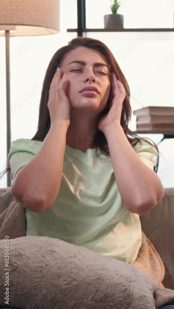 Vertical video. Headache suffer. Sick woman. Home disease. Exhausted lady feeling unbearable ...