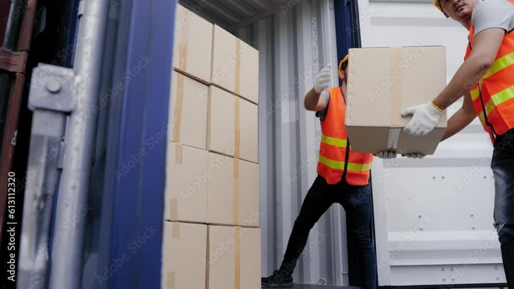 Group of strong worker help lifting and stacking together many boxes of ...