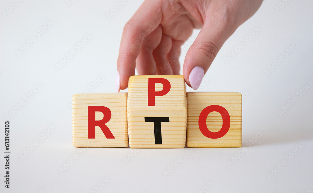 RPO vs RTO symbol. Businessman hand turns wooden cubes and changes the ...