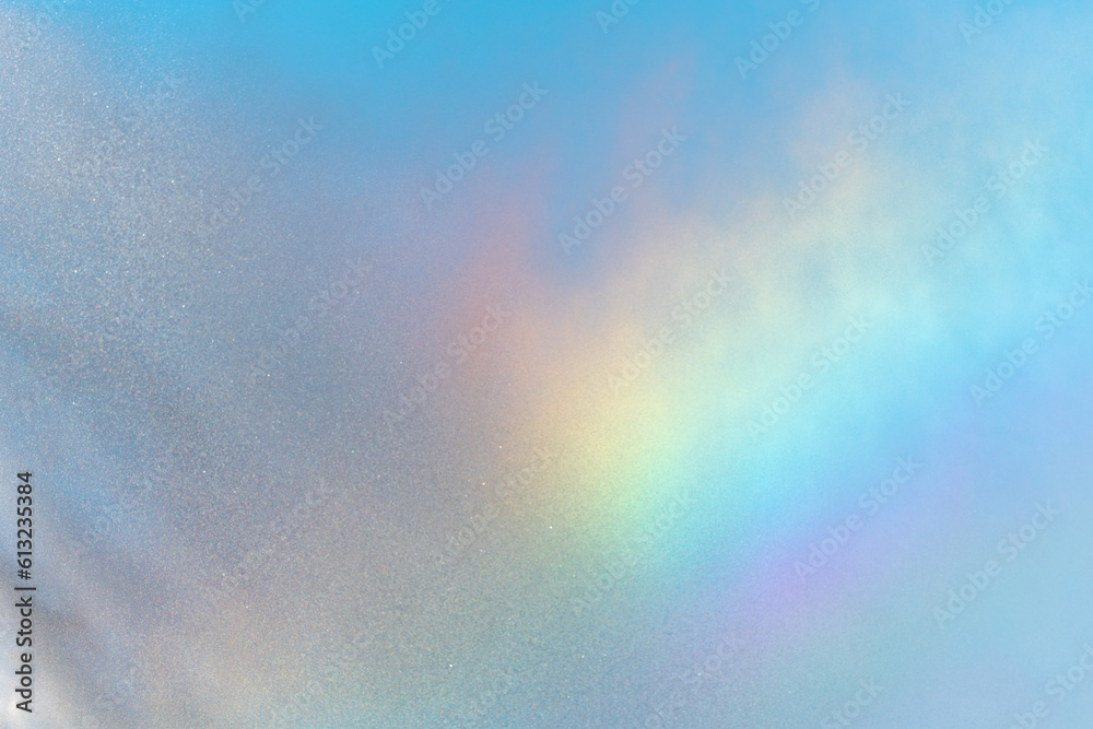 Rainbow colors in the stream of water from an agricultural sprinkler ...