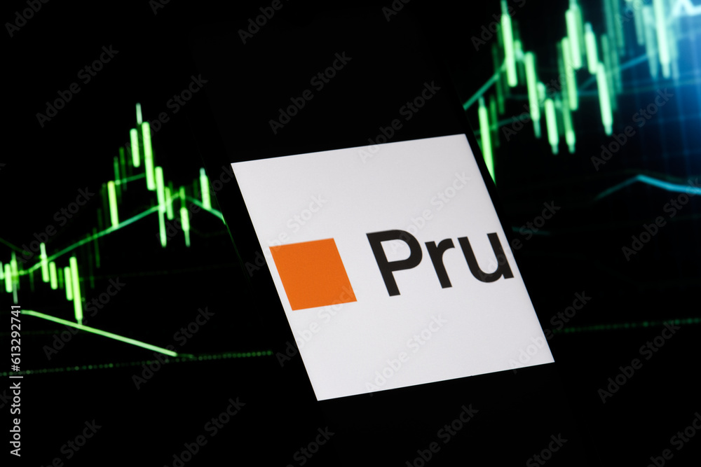 Prudential company logo (PRU) on screen of smartphone against blurred ...