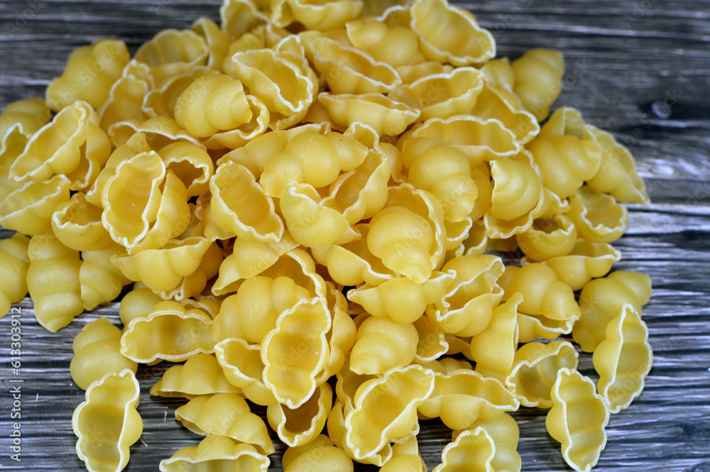 Pile of dry raw uncooked Macaroni, dry pasta shaped like snails, Made ...