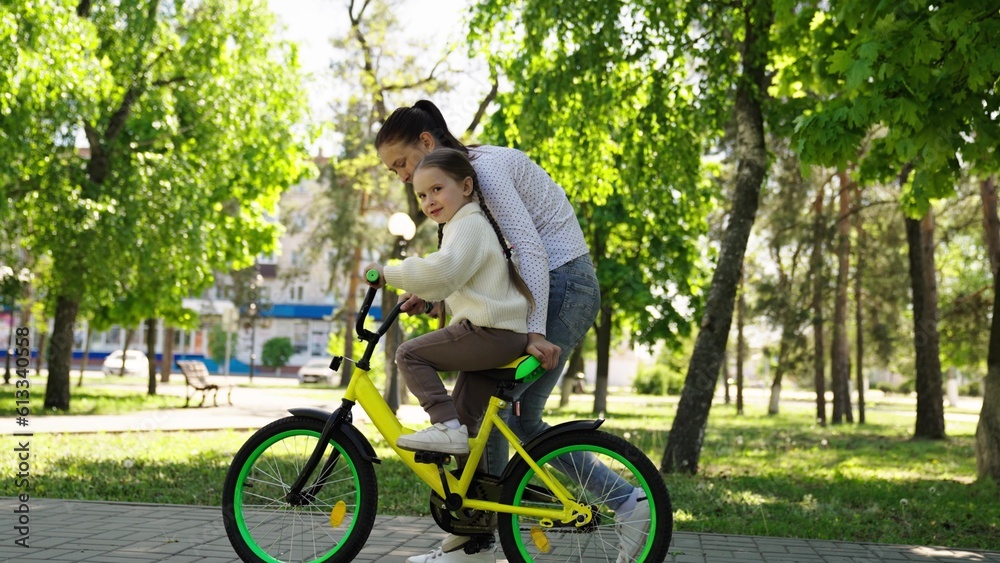 child learn ride bike. mother daughter girl park. happiness smile ...
