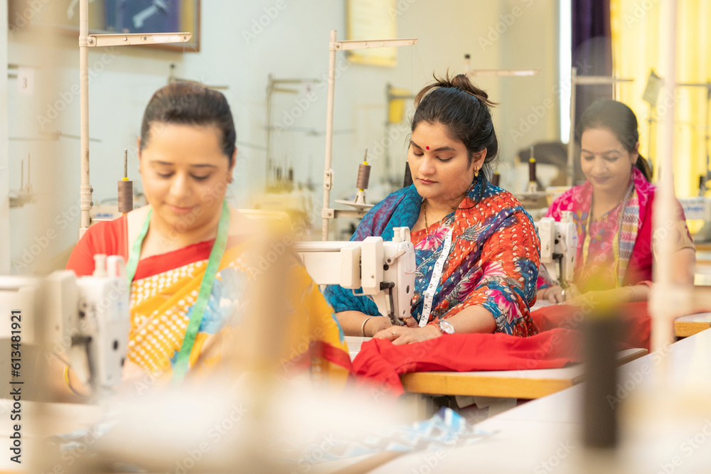 Indian women group working on sewing machine at textile factory. Stock ...