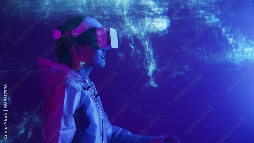 Woman in futuristic costume. Girl in glasses of virtual reality while ...