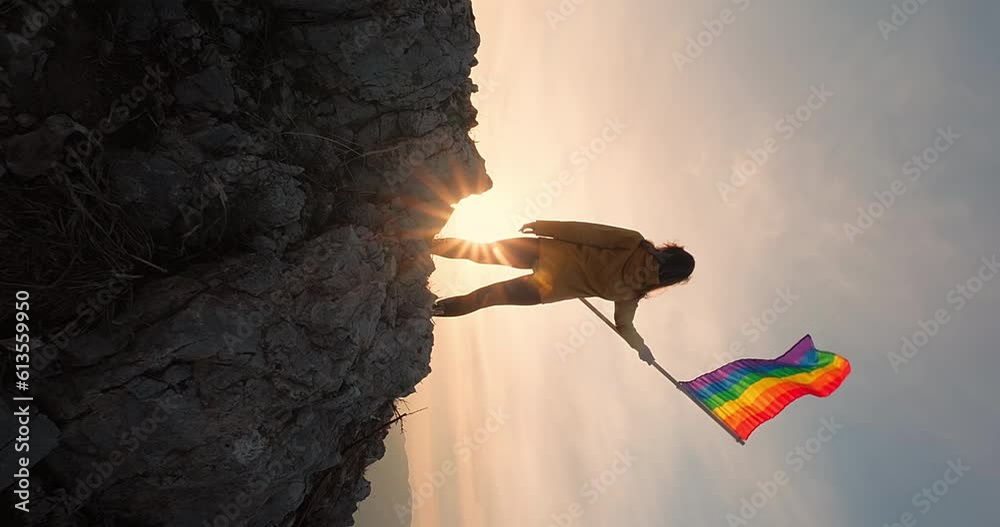 LGBTQ community rainbow flag. A symbolic moment of a woman proudly ...