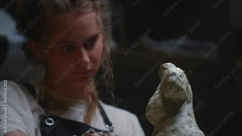 PORTRAIT: A sculptor girl creates a sculpture of a fat woman from clay ...