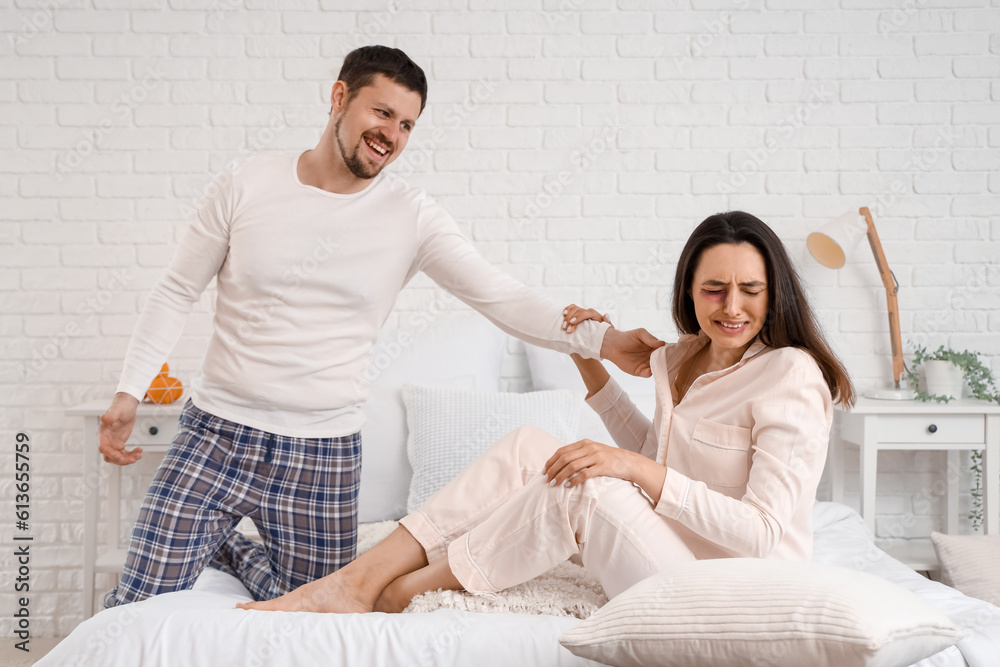 Angry husband beating his scared wife in bedroom. Domestic violence ...