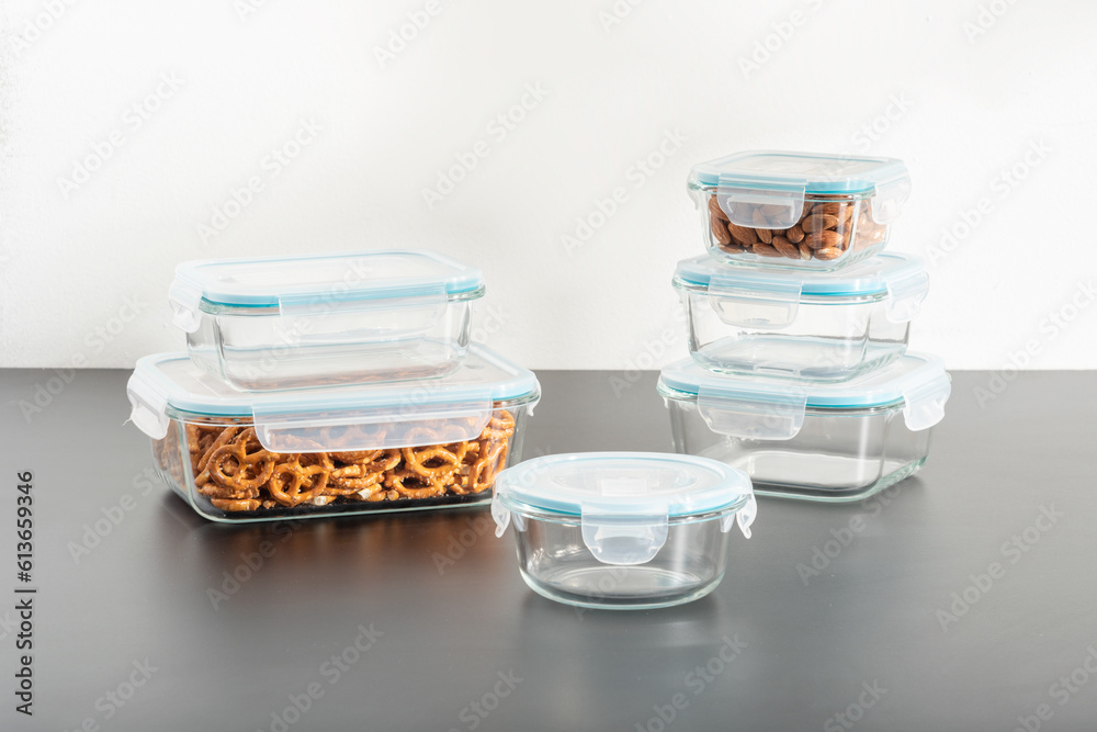 clear plastic containers with food and a transparent glass lids resting ...