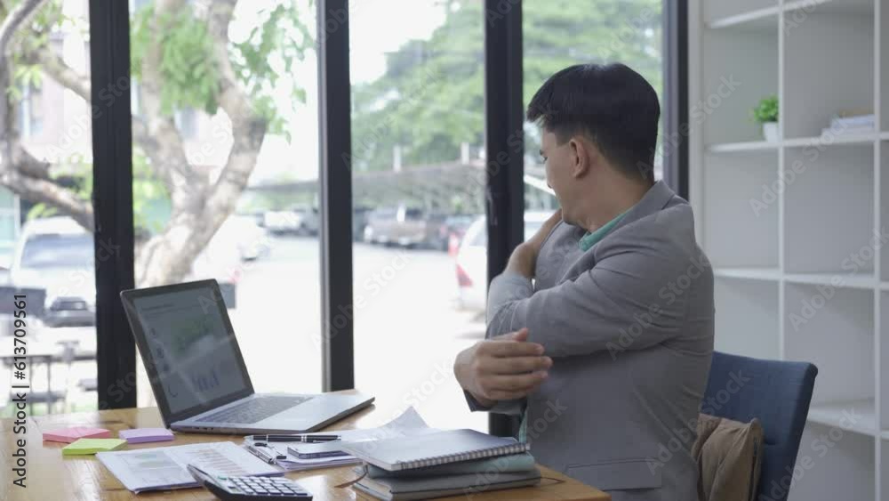 Asian business man Sitting working on laptop with office syndrome ...